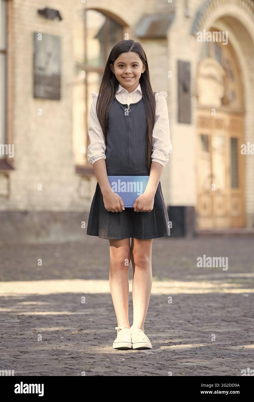 Bringing school uniform back. Happy kid wear uniform outdoors School ...