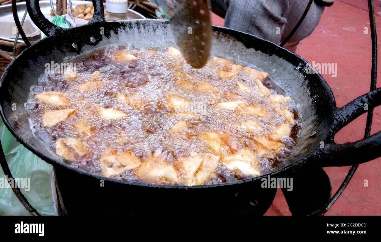Frying vegetarian snack small samosa.Indian special traditional street ...