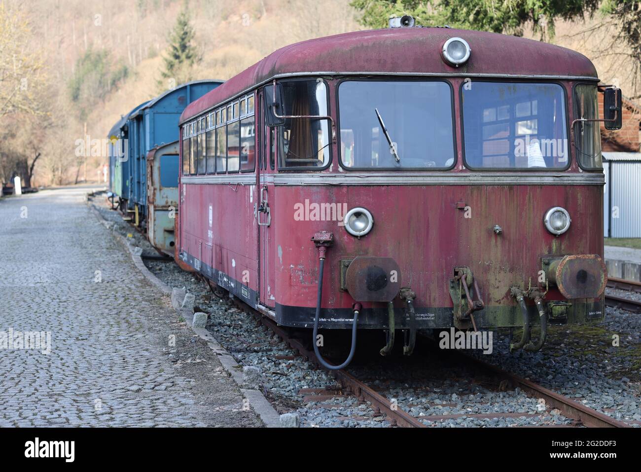 Abandoned red and blue train on rail tracks Stock Photo - Alamy