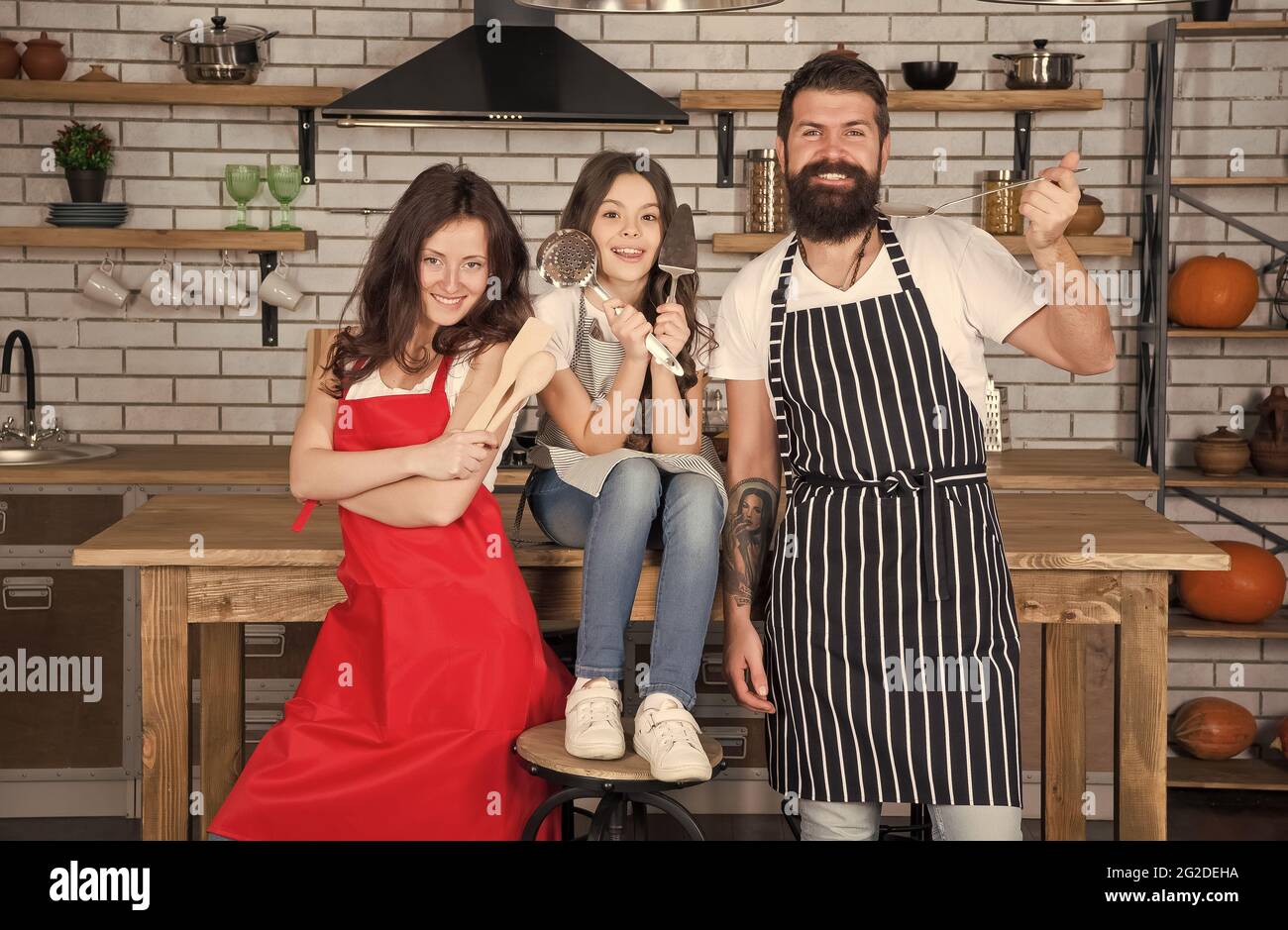 Parents mom dad and daughter cooking food together, family recipe ...