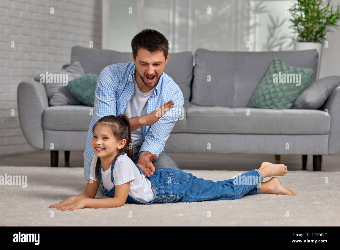 happy little child daughter doing massage to father Stock Photo - Alamy