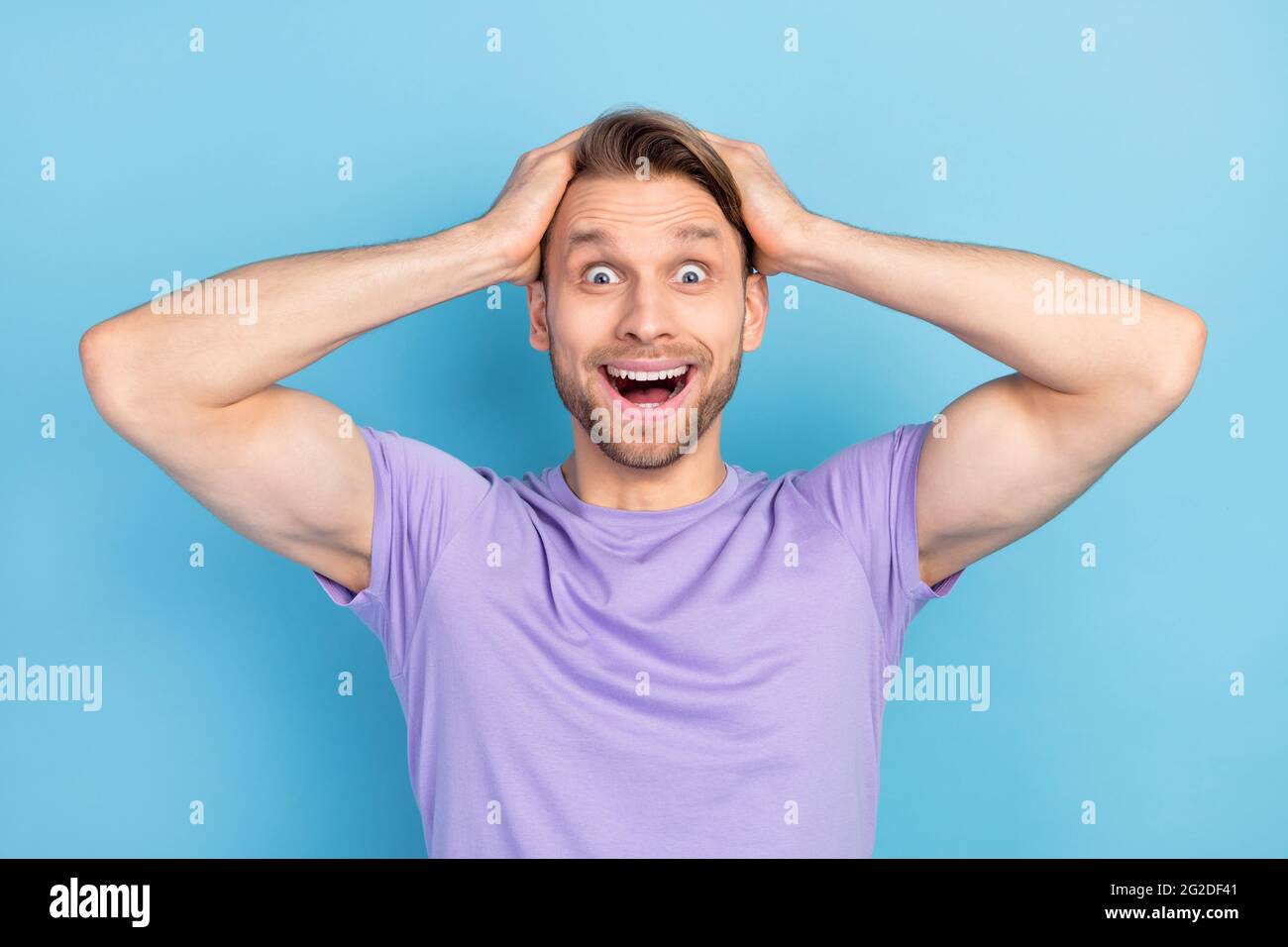 Photo of funny hooray blond hair guy wear purple t-shirt isolated on ...