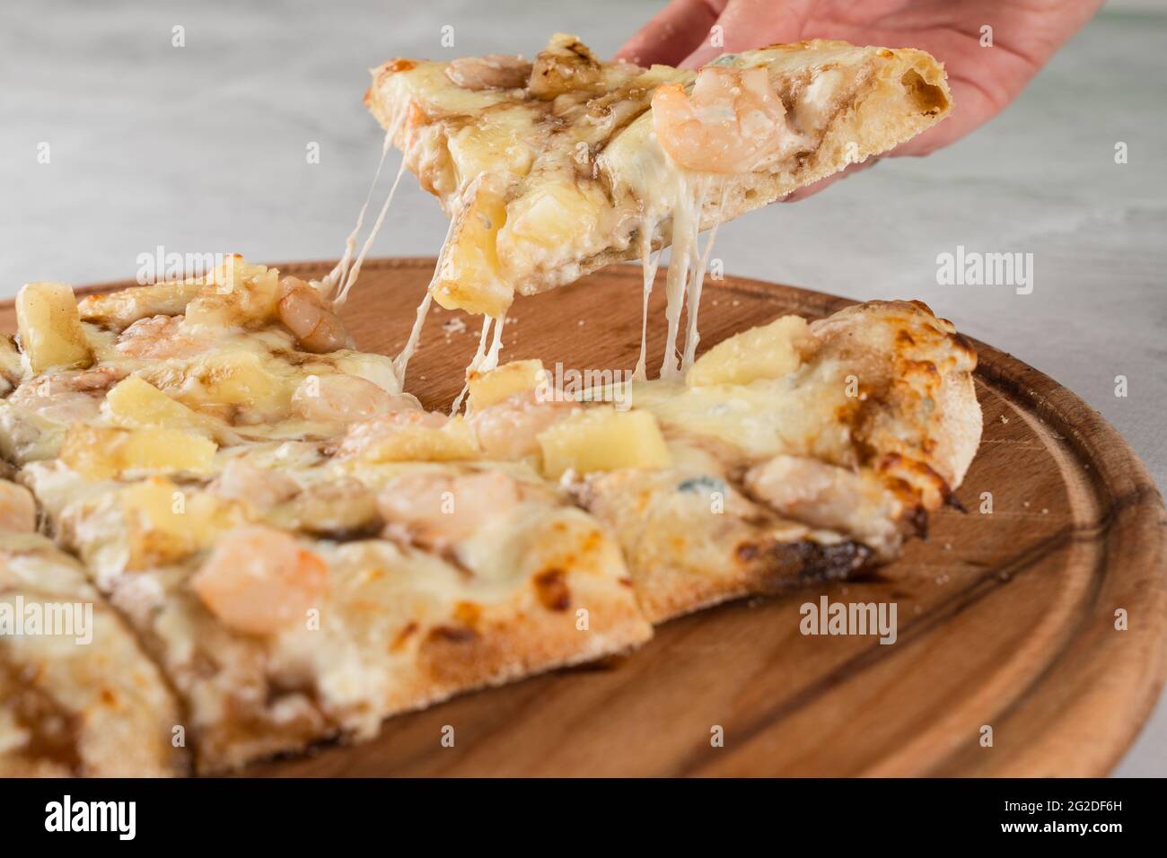 Mozzarella stretching cheese on pinsa romana gourmet italian cuisine ...