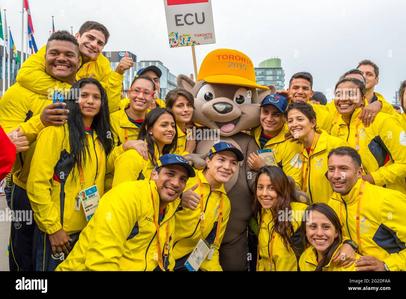 Athletes from Ecuador posing for a photograph with the mascot Pachi the ...