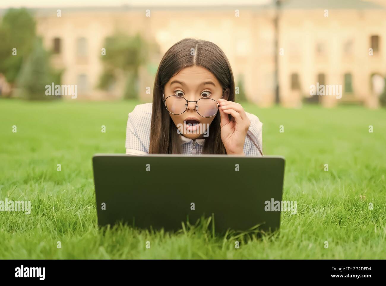 Shocked and surprised kid on internet with digital computer feel ...