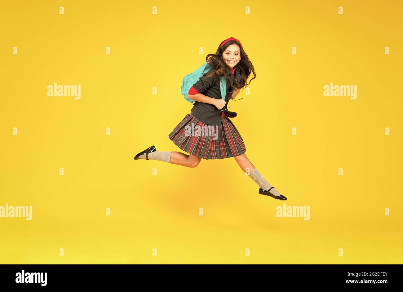 Happy little girl child in uniform hurry to school carrying backpack in ...