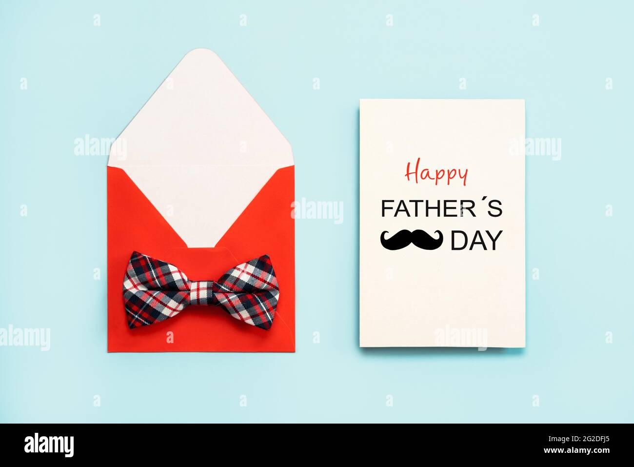 Happy Father's Day. Red envelope with bow tie and white paper with the ...