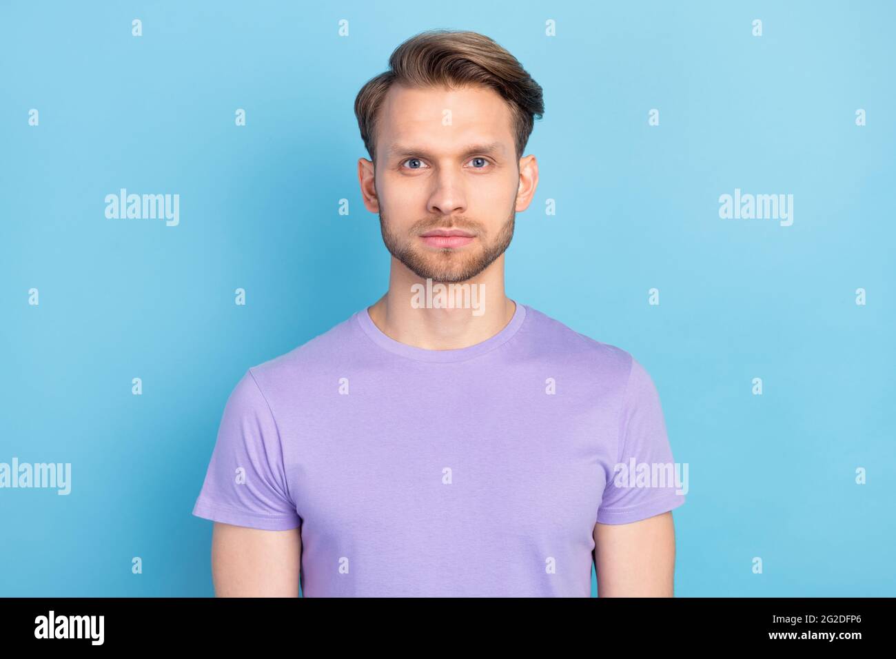 Photo of handsome serious blond hair guy wear purple t-shirt isolated ...