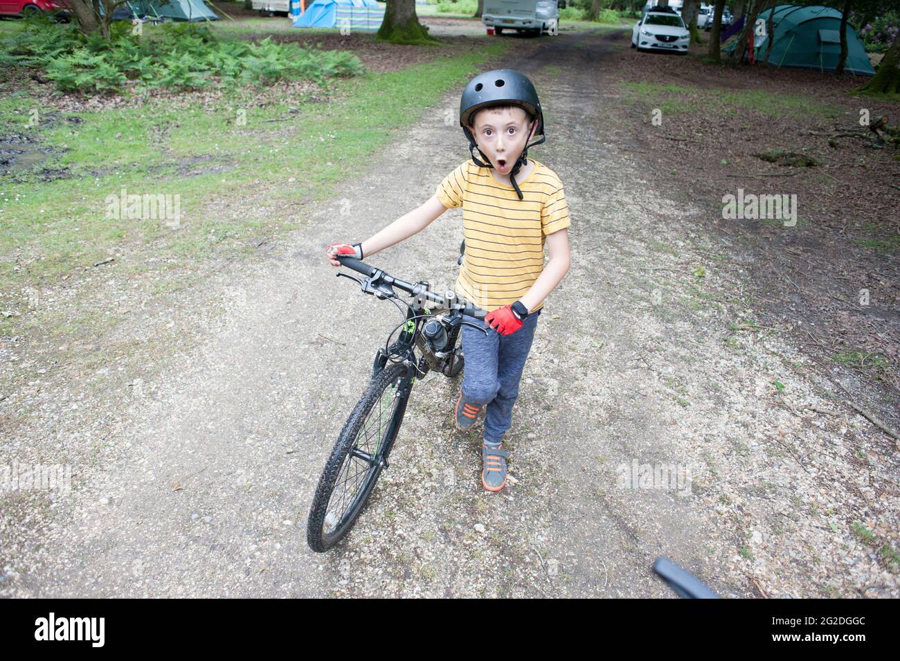 A kid on a childs bike on a cycle path wearing a helmet Stock Photo - Alamy