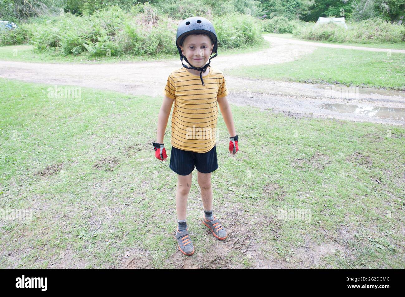 A kid on a childs bike on a cycle path wearing a helmet Stock Photo - Alamy