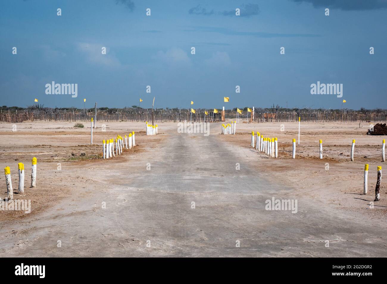 Rustic Sand Road with Yellow and White Painted Wooden Posts Fence at ...
