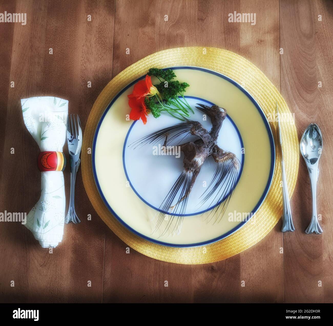 Still life featuring a table setting with fine dinnerware and a dead ...