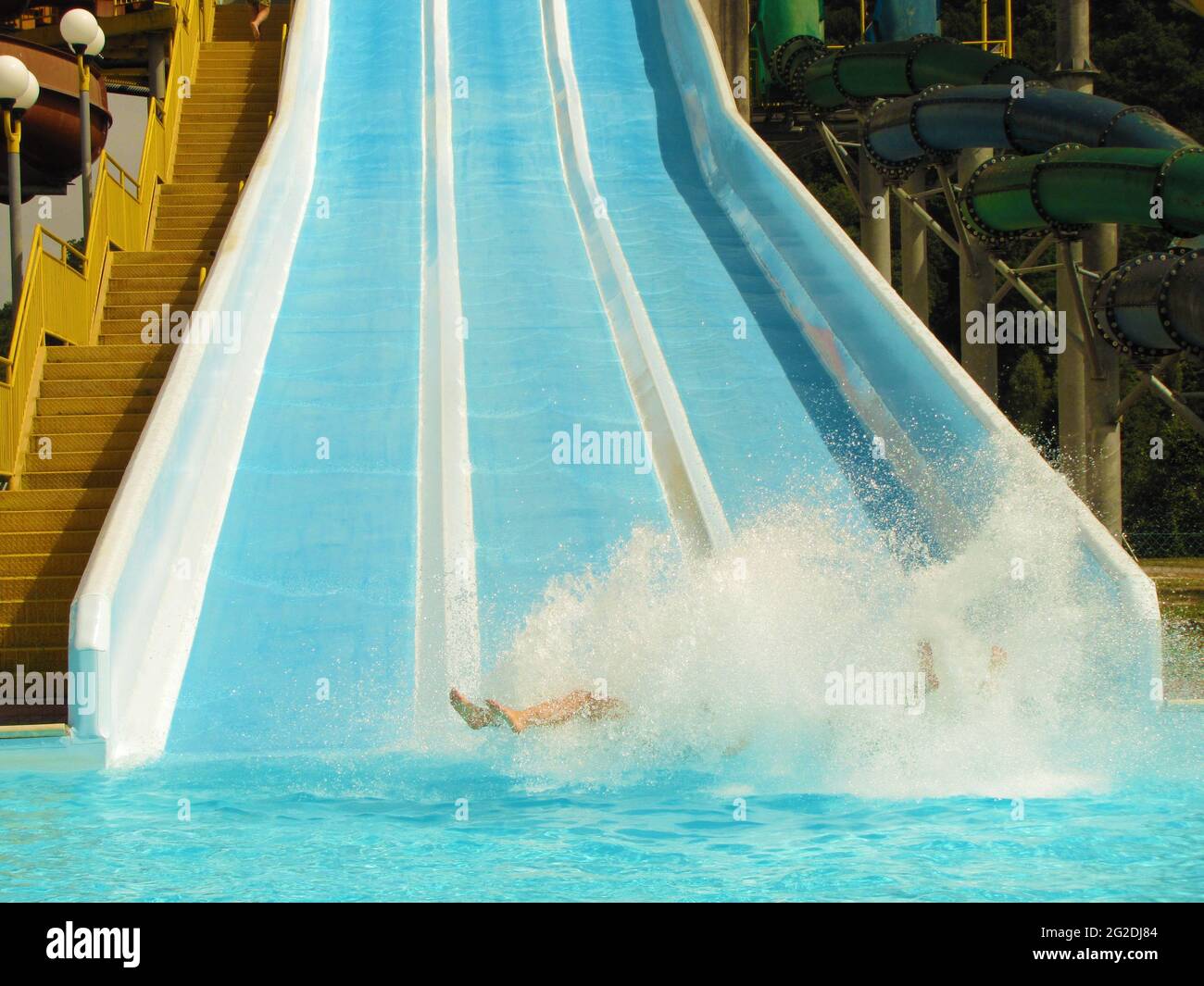 Person sliding down on water-slides into a pool Stock Photo - Alamy
