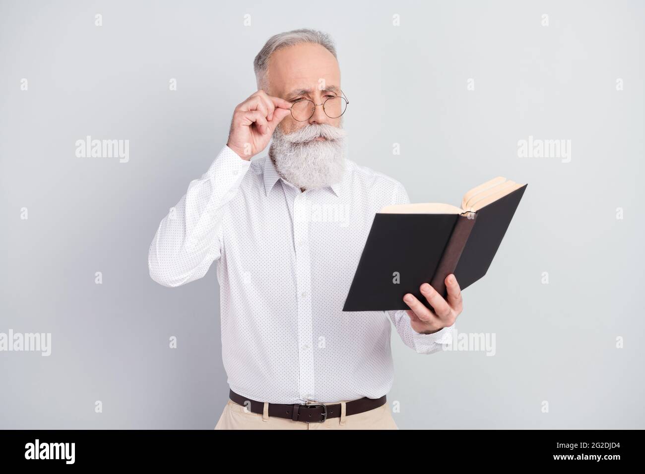 Photo of minded smart old man wear glasses red book novel wear white ...