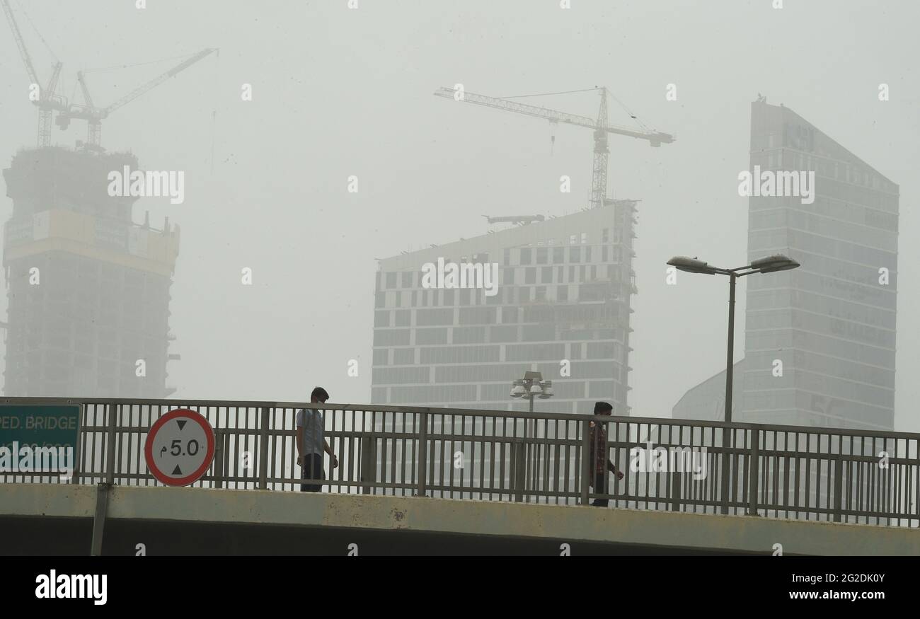 Kuwait City, Kuwait. 10th June, 2021. People walk across a pedestrian ...