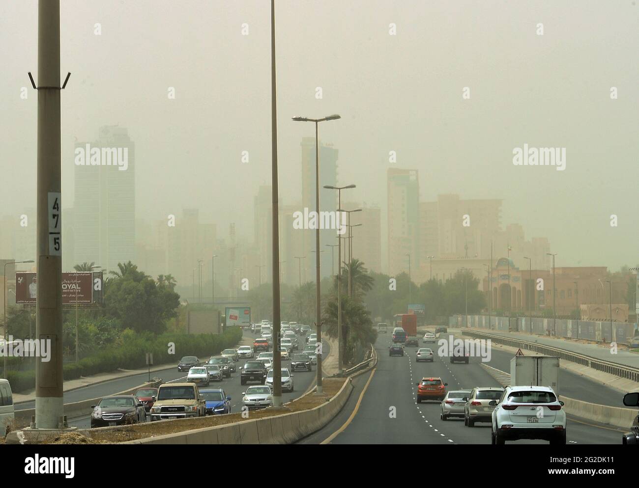 Kuwait City, Kuwait. 10th June, 2021. Vehicles run on a road in dust in ...