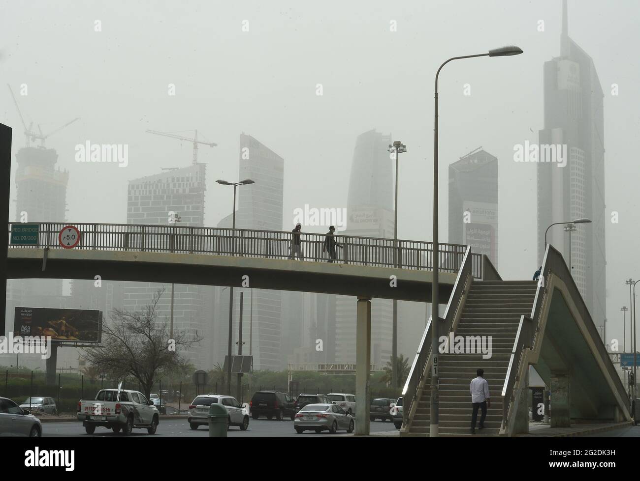 Kuwait City, Kuwait. 10th June, 2021. People walk on a pedestrian ...