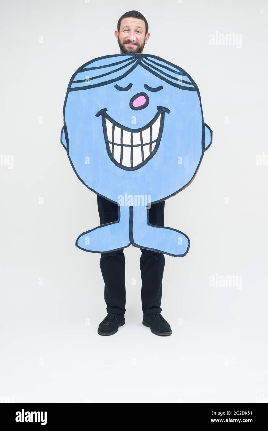 A person standing with a cardboard cut out of a little miss / mr men ...