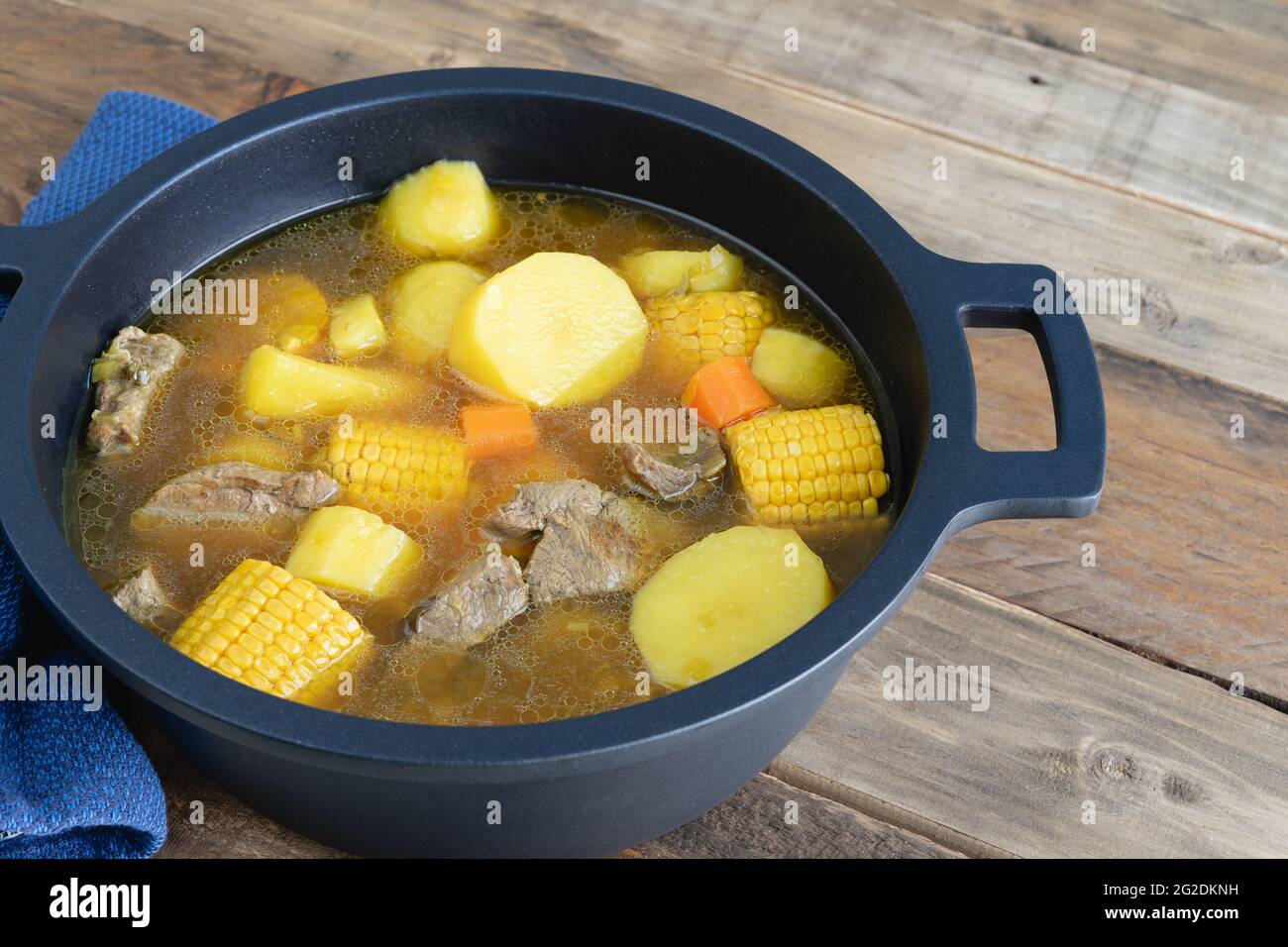 Colombian Sancocho freshly made in a pot on a wooden bottom. Copy space ...