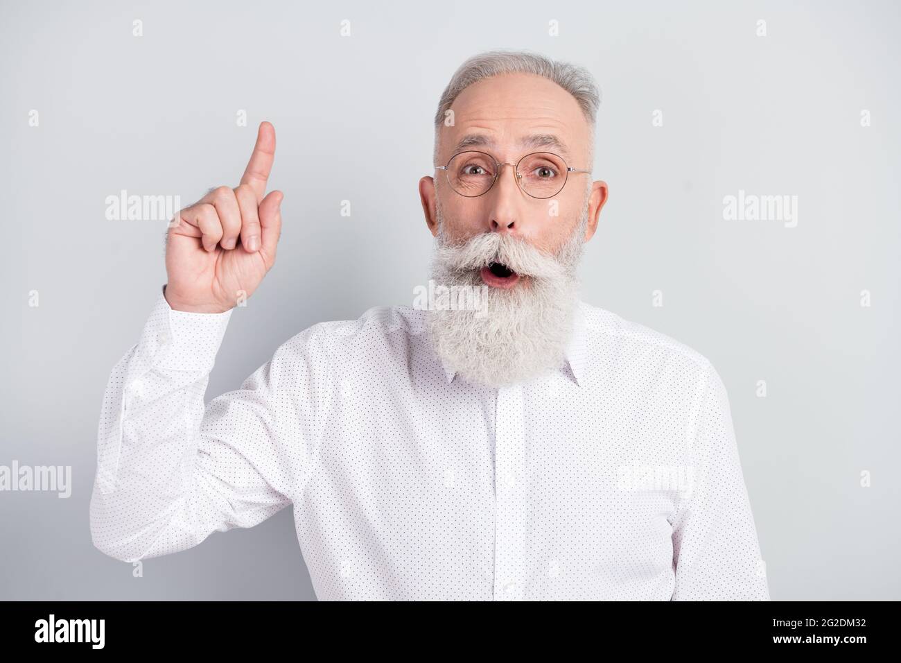 Portrait of handsome impressed grey hair old man point up wear ...