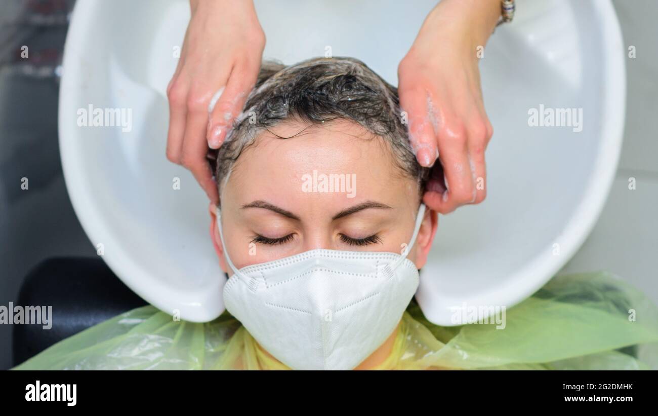 Washing the head in the barbershop, hair care, the hairdresser washes ...