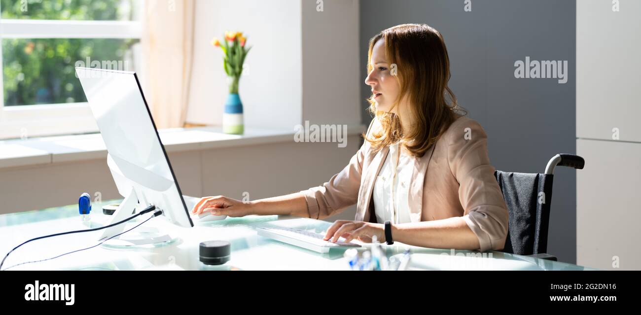 Handicapped Businesswoman Using Desktop Computer At Office Desk Stock ...