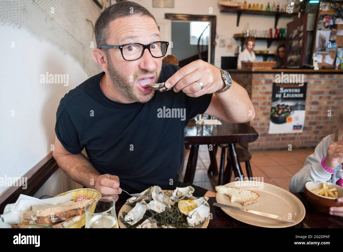 Man eating fish at restaurant hi-res stock photography and images - Alamy