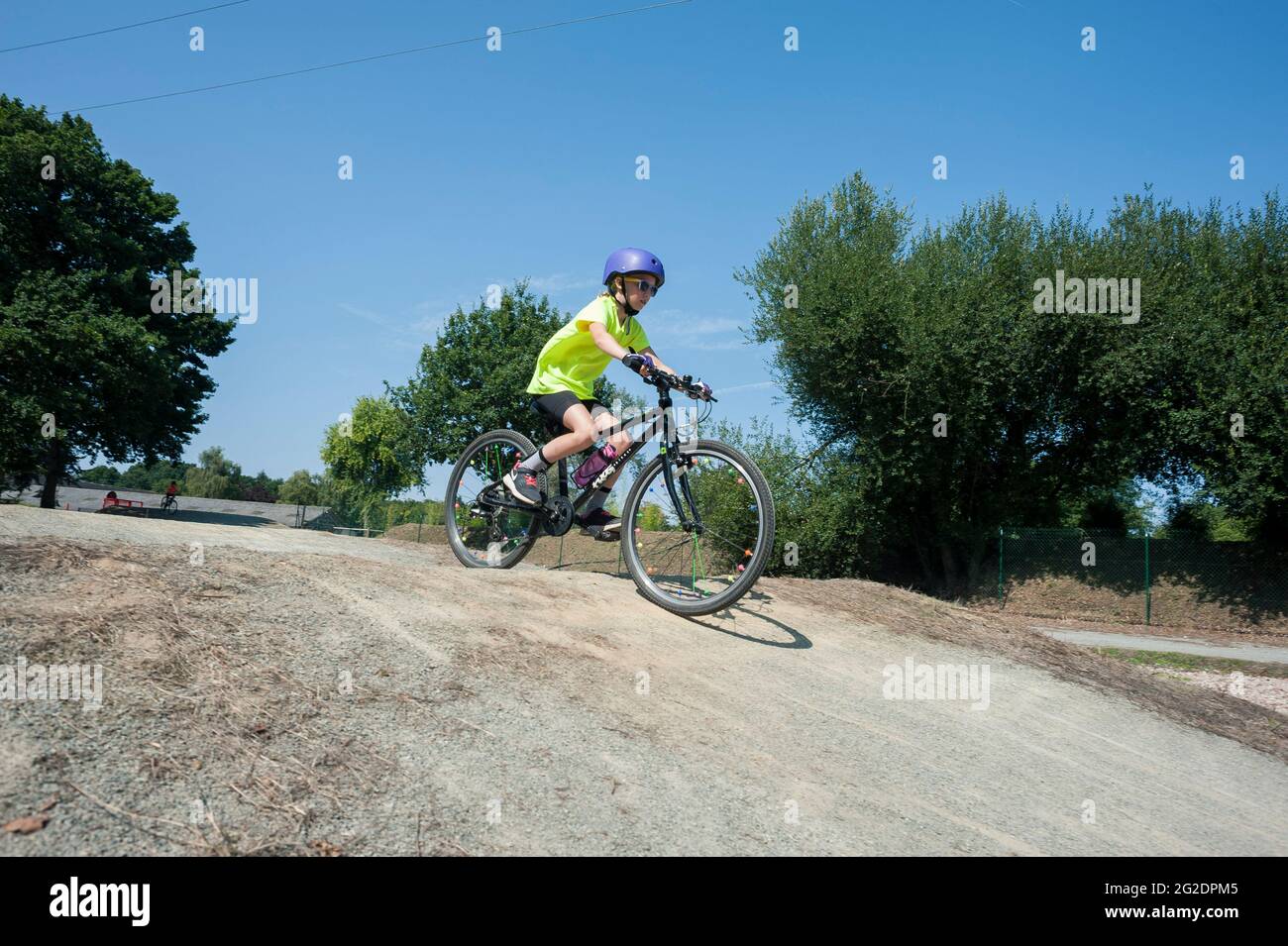 A family riding bikes in France in the summer on cycle paths exploring ...