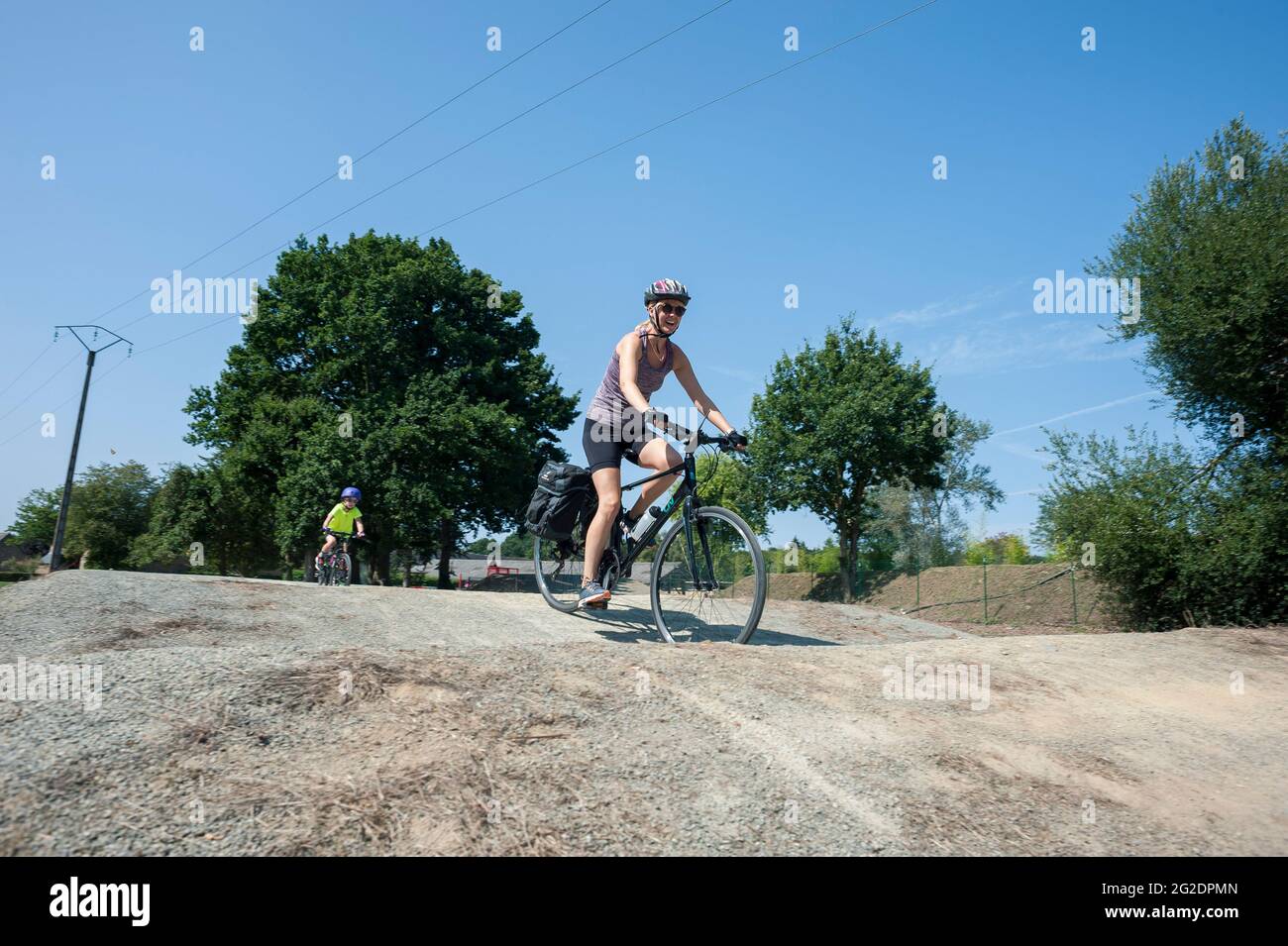 A family riding bikes in France in the summer on cycle paths exploring ...