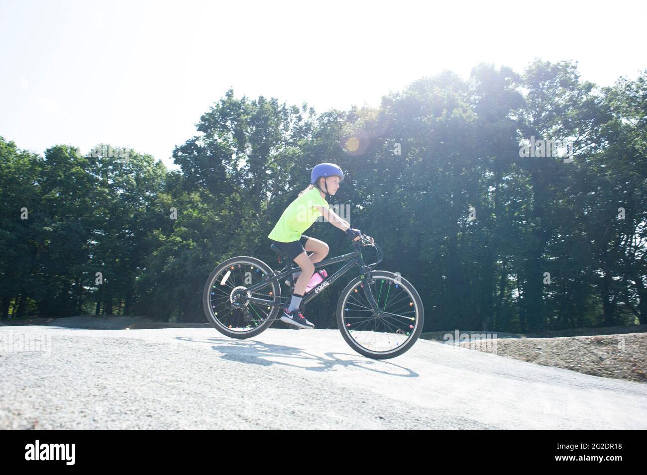A family riding bikes in France in the summer on cycle paths exploring ...