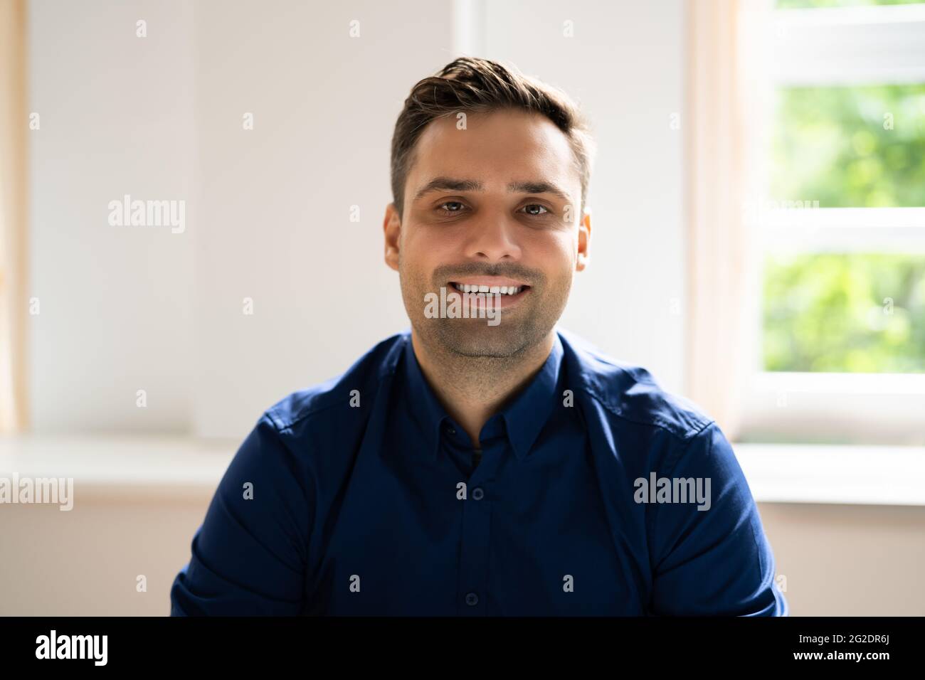 Young man smiling video conference hi-res stock photography and images ...