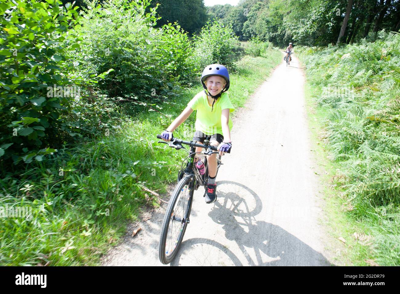 A family riding bikes in France in the summer on cycle paths exploring ...