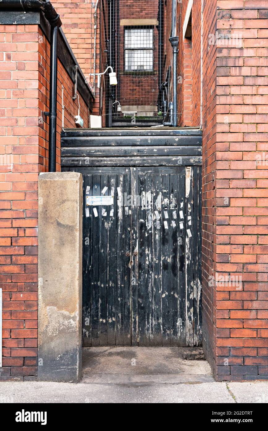 Back street gate at rear of old building Stock Photo - Alamy