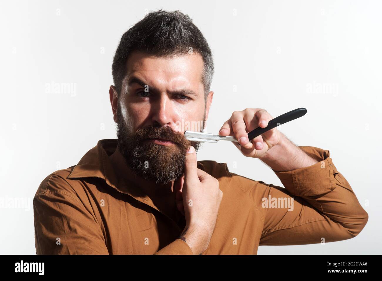 Bearded man with straight razor for shaving. Stylish hairdresser with ...