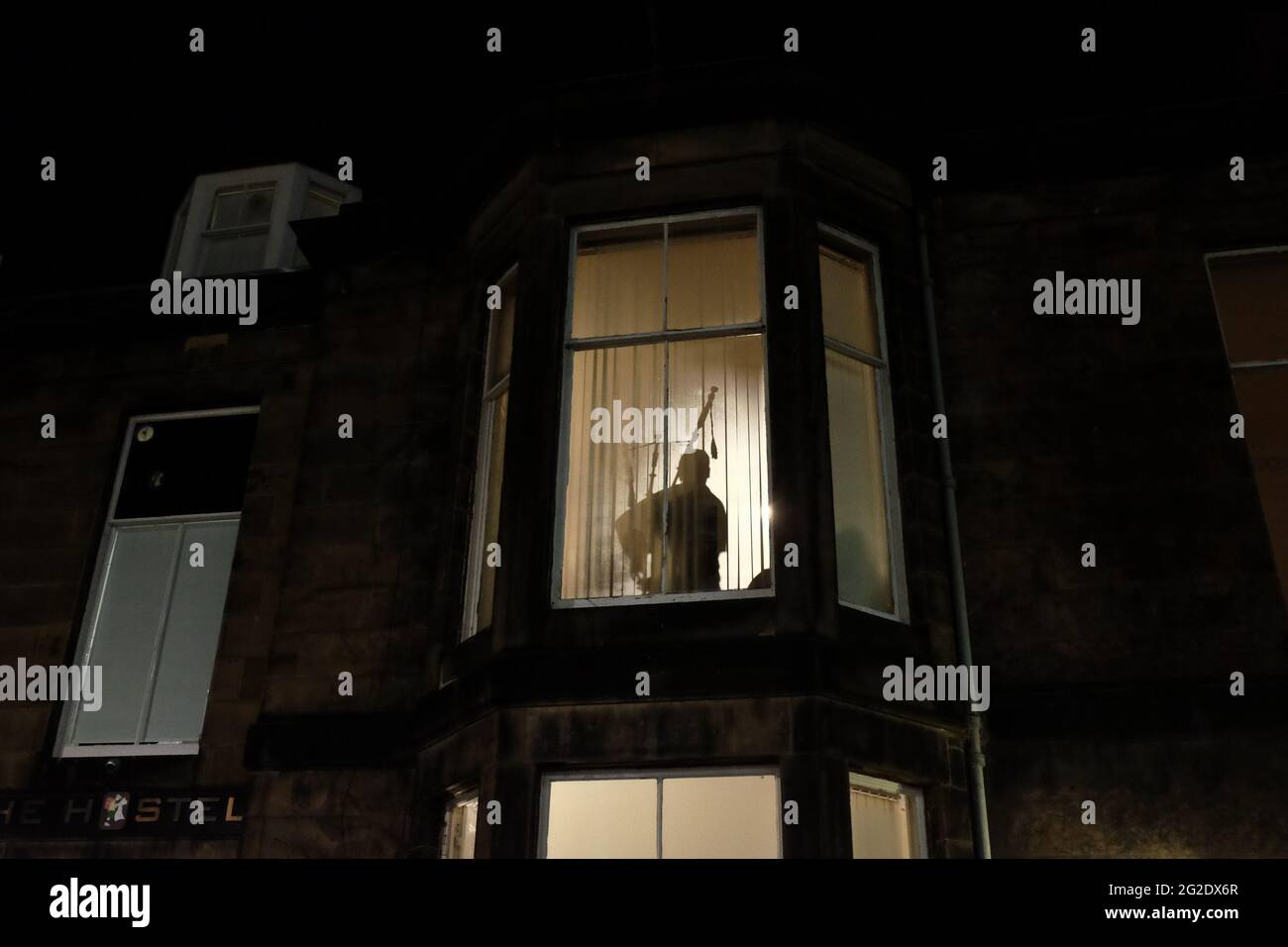 A piper playing the pipe at a house in Edinburgh, after Scotland beat ...