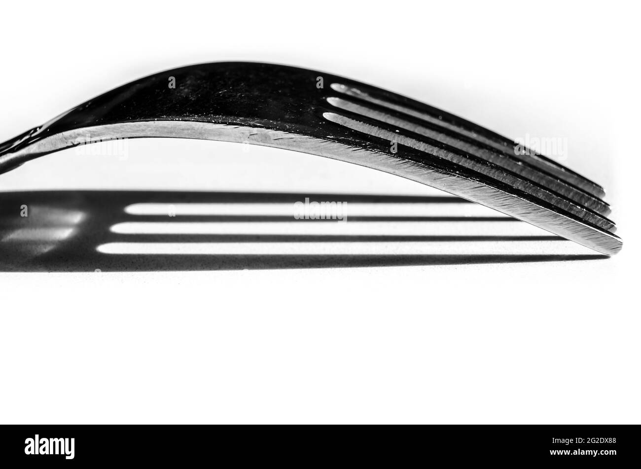 Closeup shot of a fork and its reflection on an isolated background ...