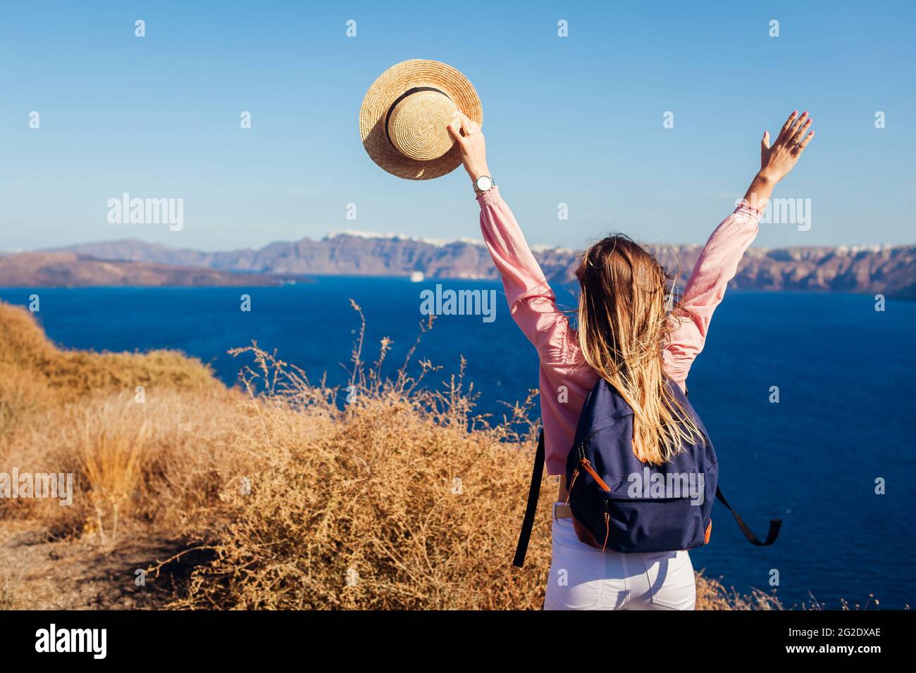Traveler woman walking on Santorini island, Greece enjoying landscape ...