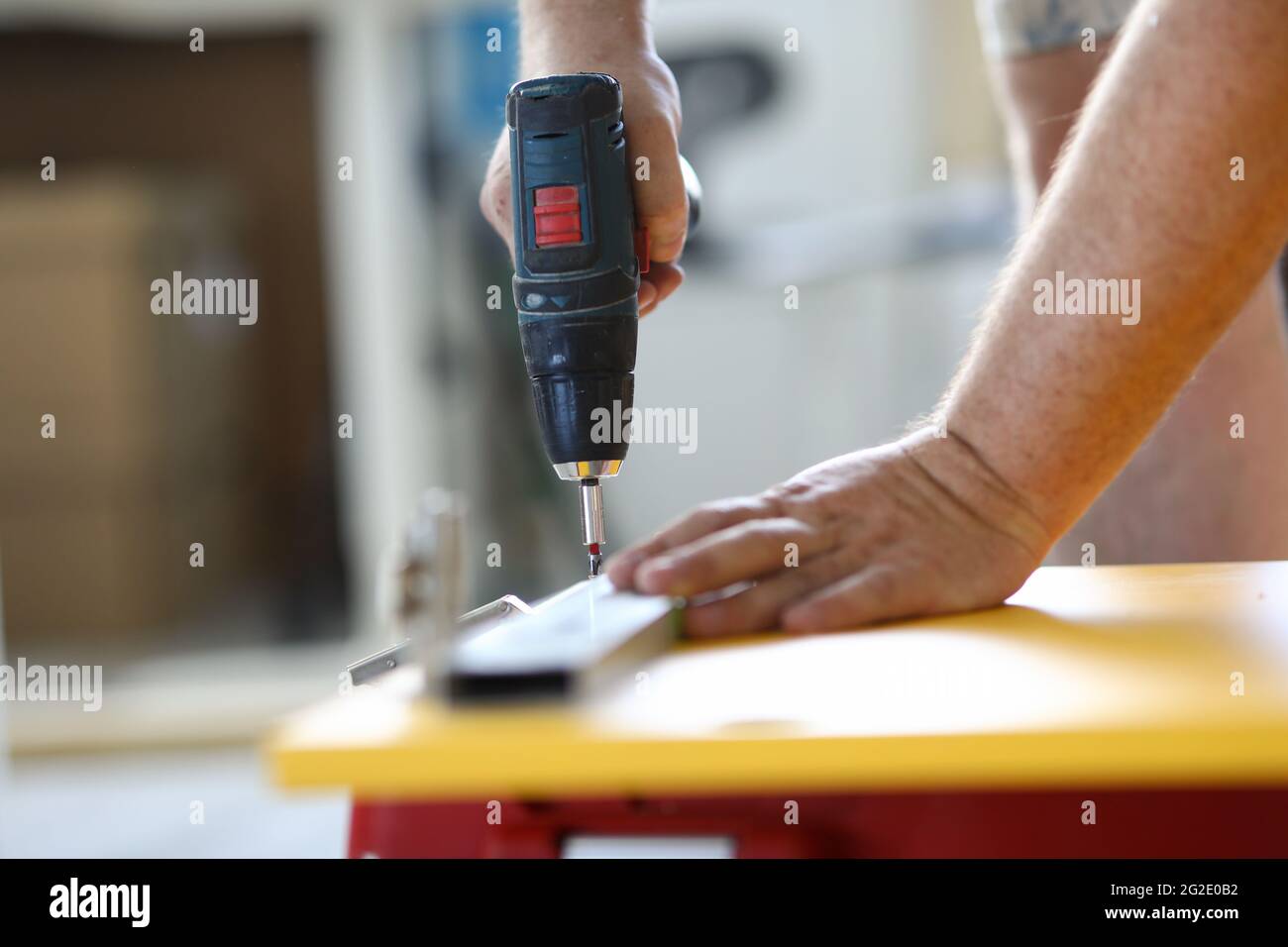 Hand with screwdriver fasten details with close-up Stock Photo - Alamy