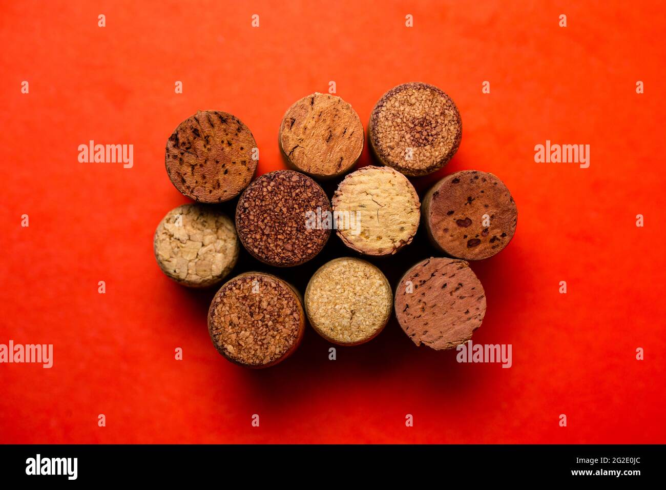 Cork from wine of different kinds on a red background view from above ...