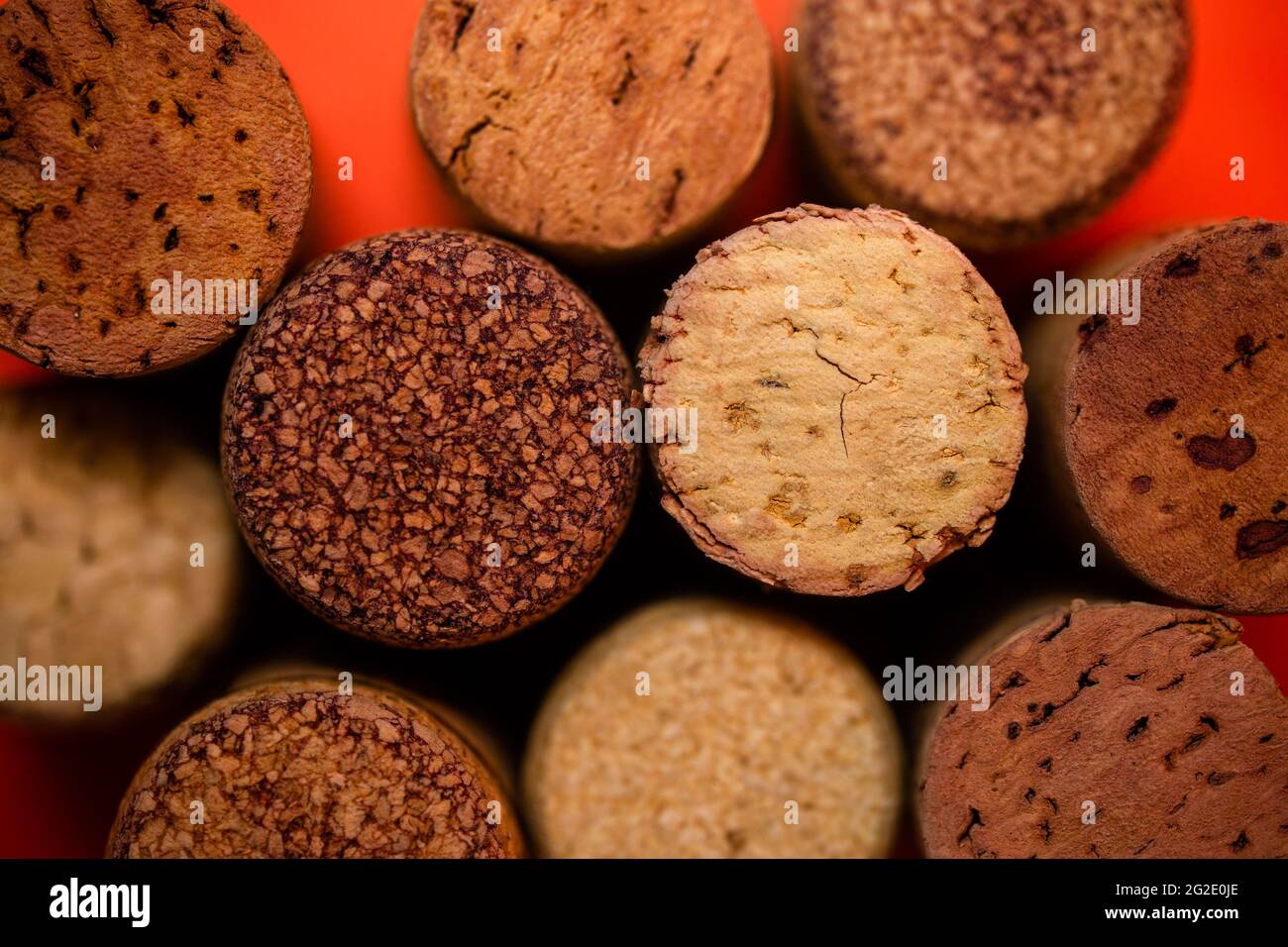Cork from wine of different kinds on a red background view from above ...