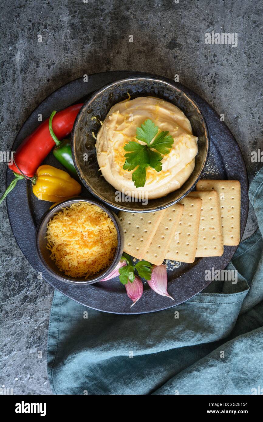 Easy cheddar cheese dip with garlic, served with crackers Stock Photo ...