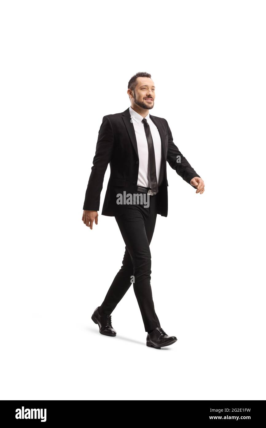Full length portrait of a young businessman walking fast isolated on ...
