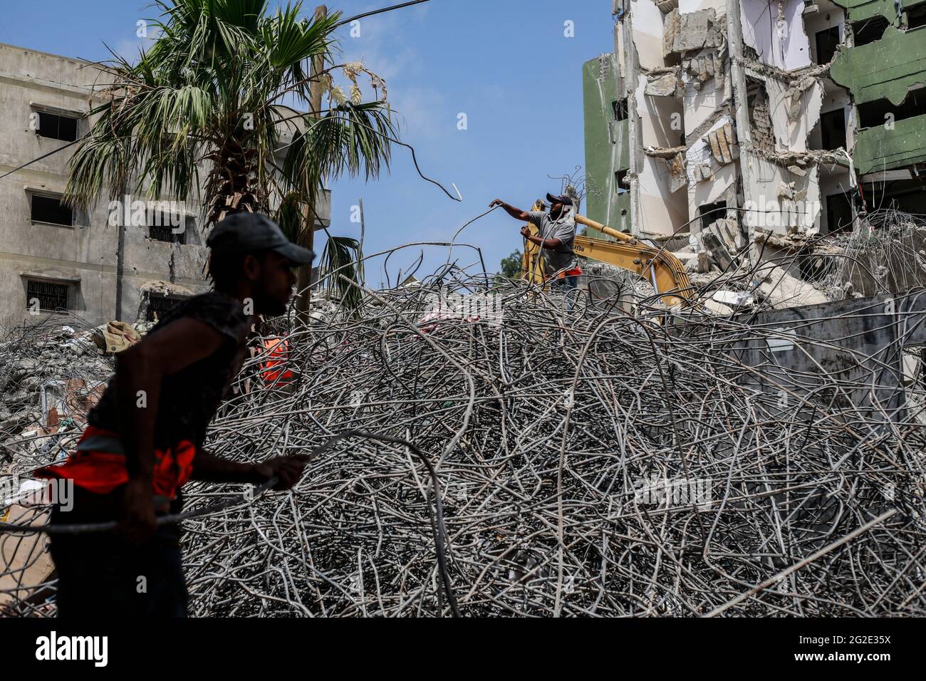 Palestinian workmen working on the rebar that was extracted from the ...