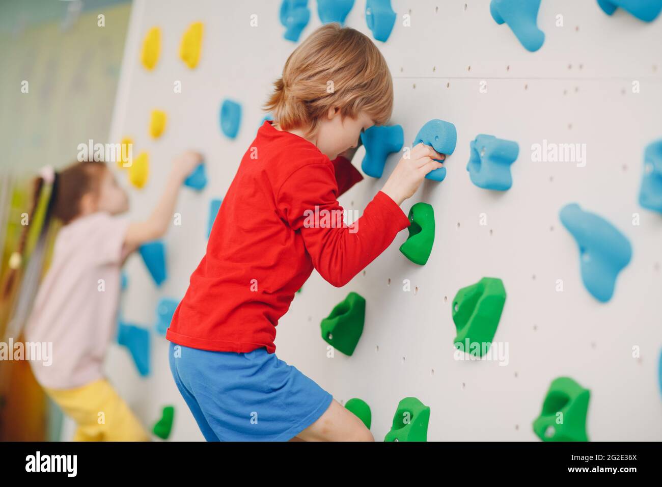 Little preschooler boy at climbing wall. Children sport, healthy ...