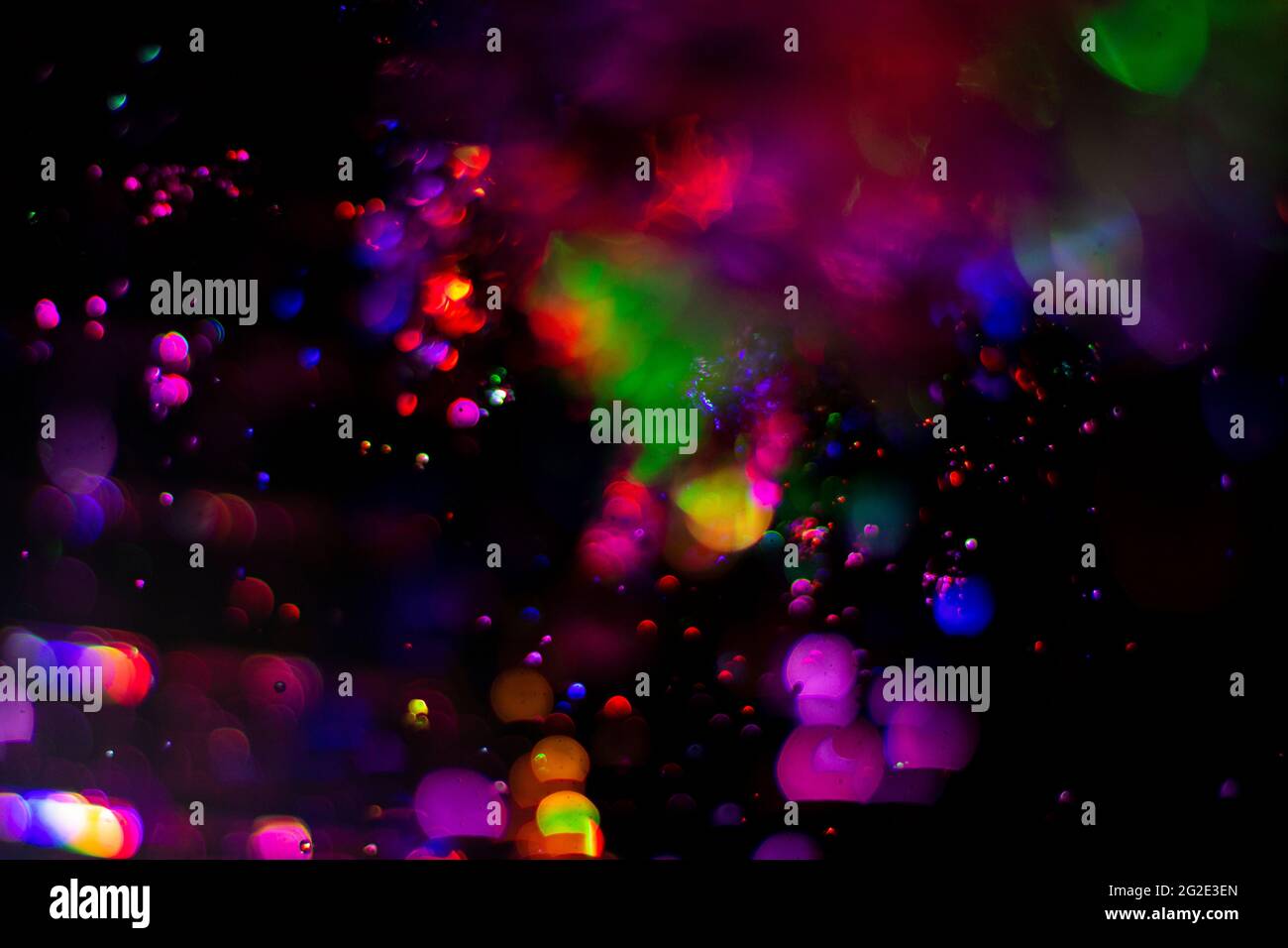 Colored water texture. Splashes of water lit in different colors. Close ...