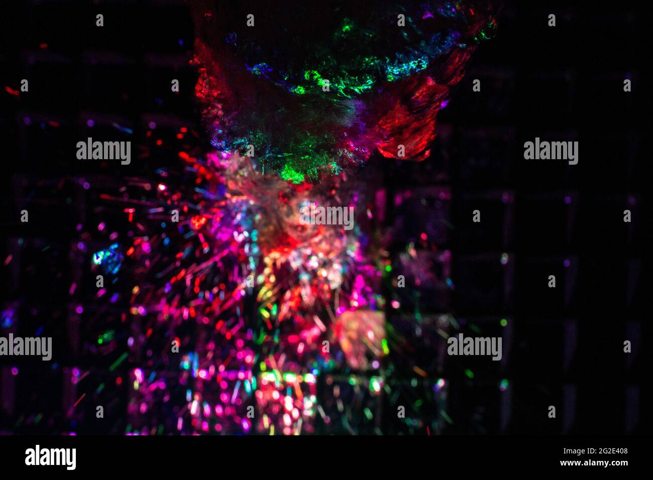 Colored water texture. Splashes of water lit in different colors. Close ...