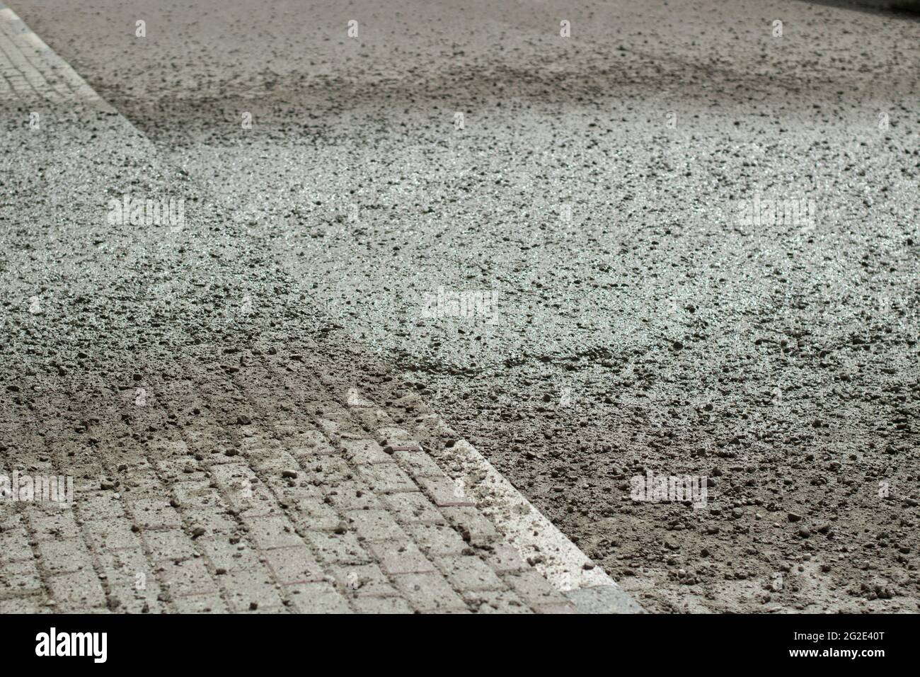 Liquid cement at a construction site. Cement spilled onto the road. The ...