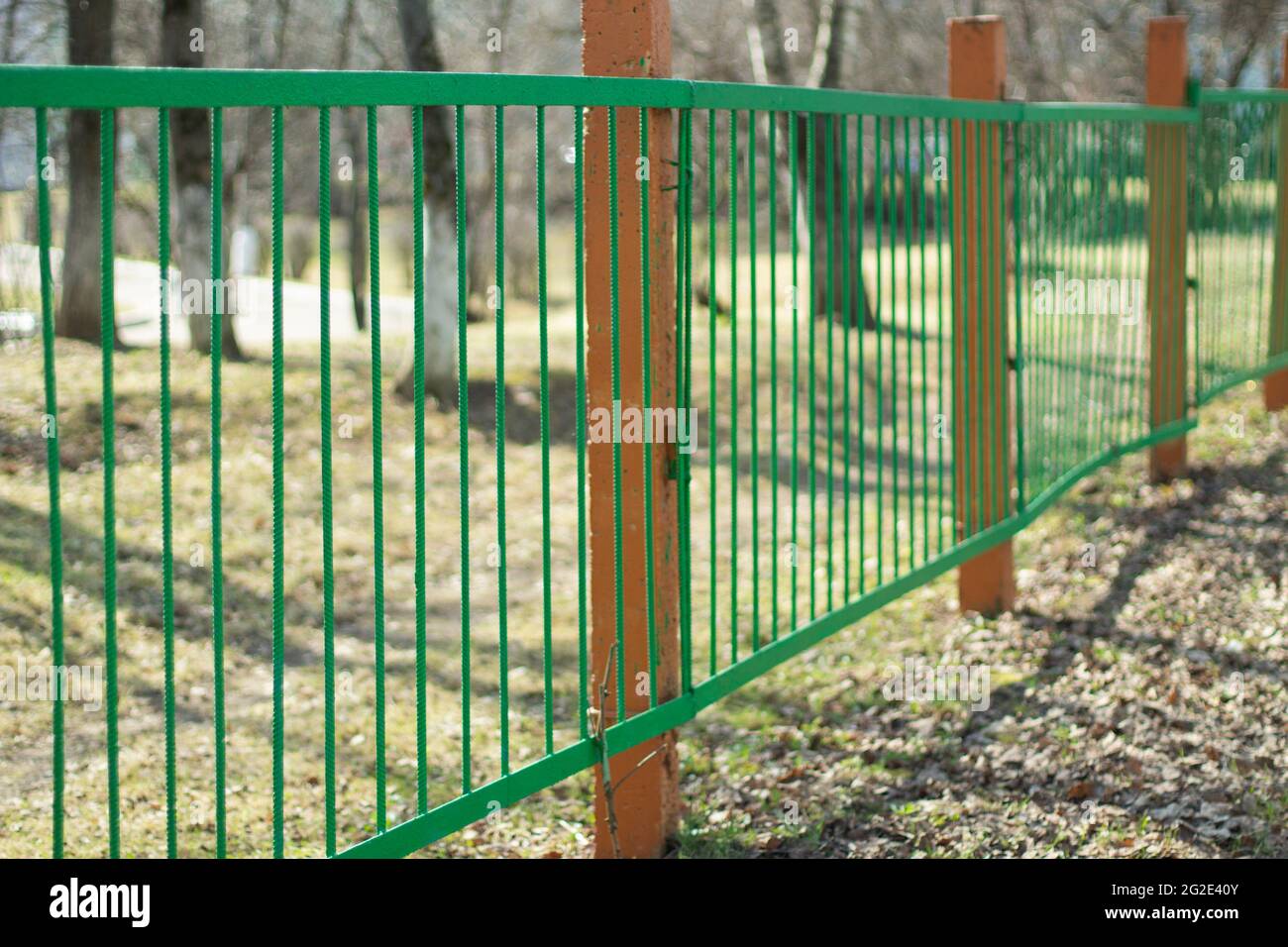 Green fence. Fencing around the territory. Metal fence on the street ...