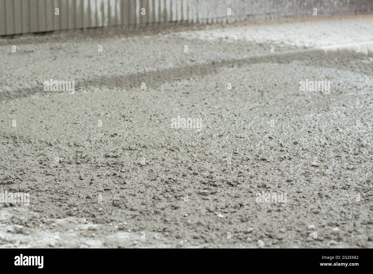 Liquid cement at a construction site. Cement spilled onto the road. The ...