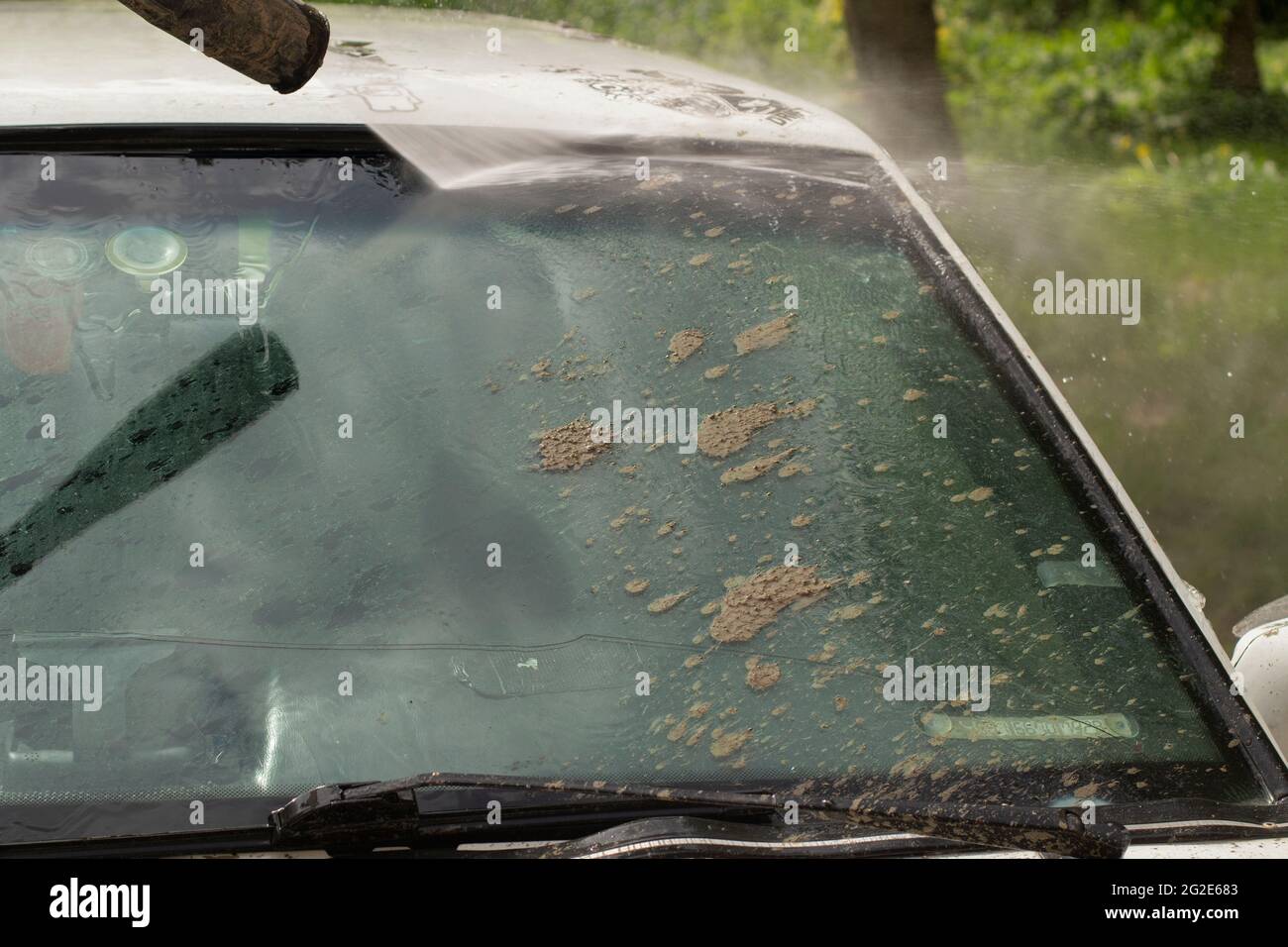 Washing the windshield from dirt. The car is washed by the pressure of ...